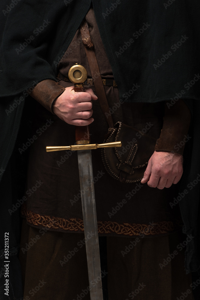 cropped view of medieval Scottish knight in mantel with sword Stock ...