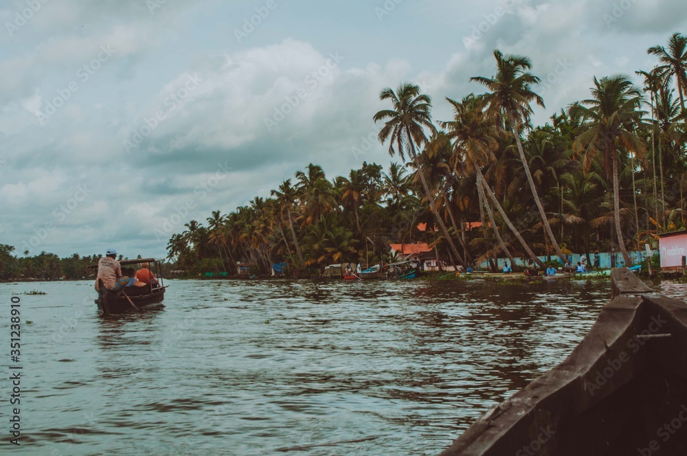 Canoes in the backwaters of Kerala, India Stock Photo | Adobe Stock