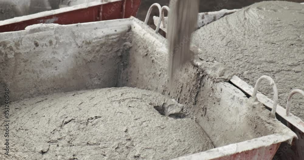Liquid cement mortar poured into metal building pallet, technology for ...