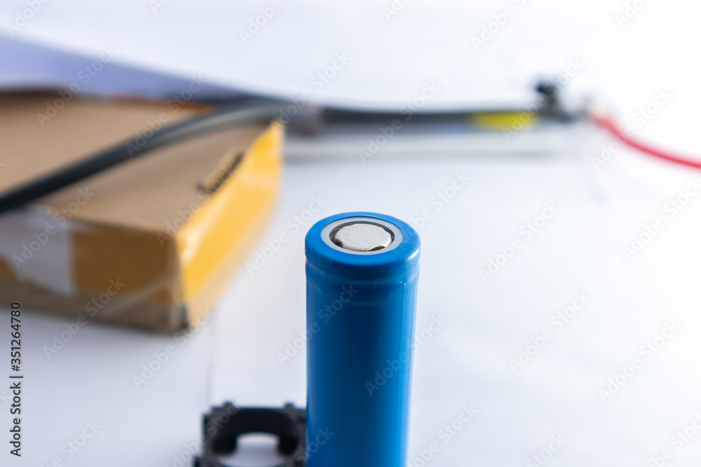 Blue lithium ion battery which placed vertically with blurred ...