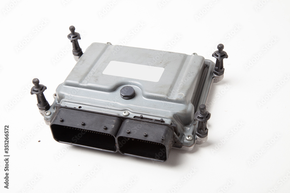 A plastic car engine control unit with metal elements on a white ...