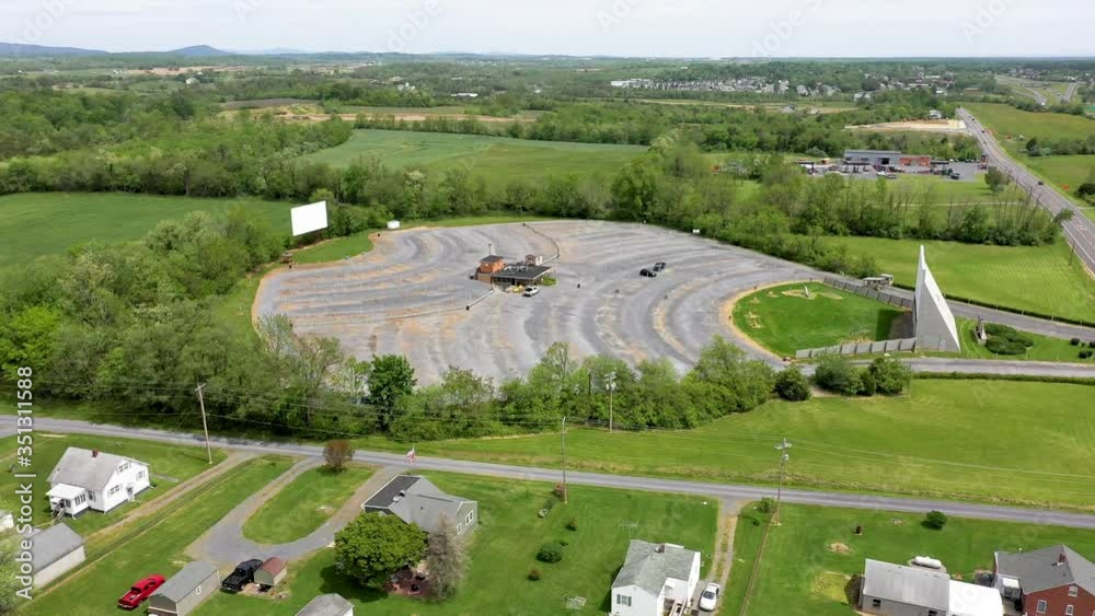 Aerial orbit of a drive-in movie theater with two separate screens ...