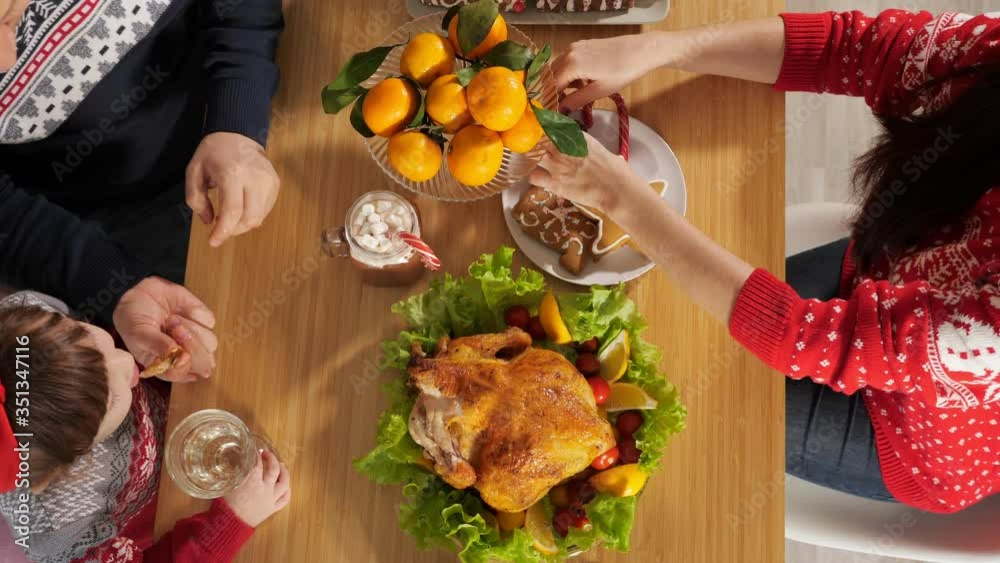 family eat chicken sitting at celebration dinner on christmas eve top view Stock ビデオ | Adobe Stock