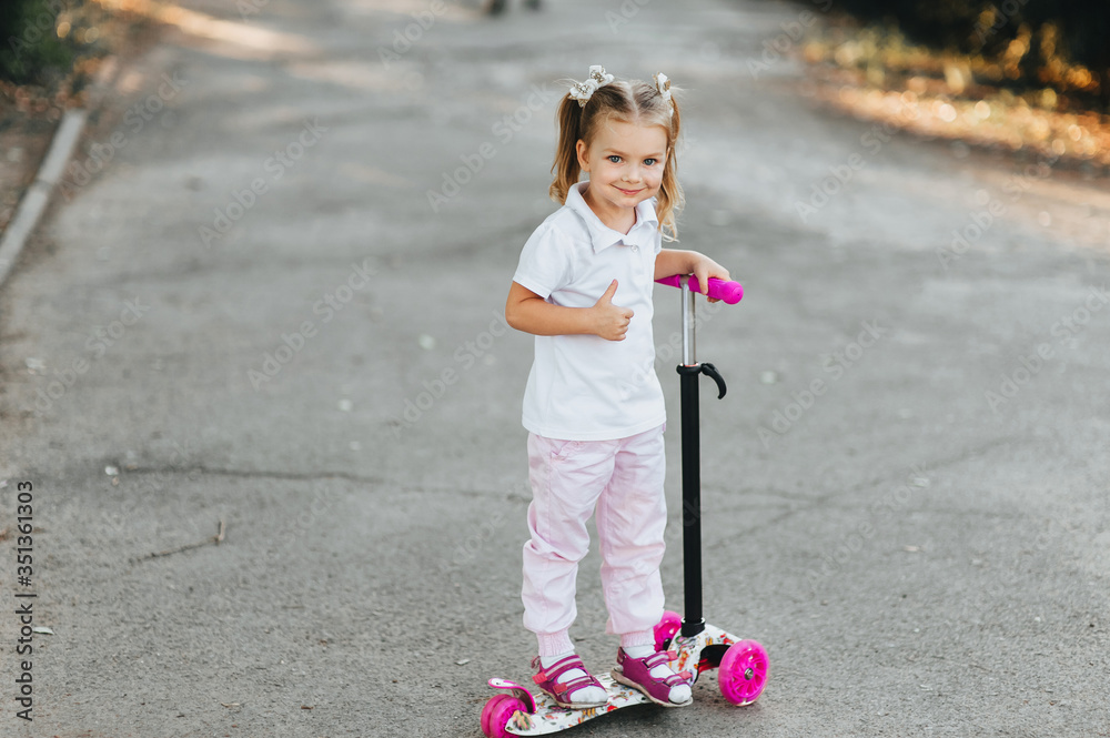 Little girl with pigtails and hairpins on her hair, the child is ...