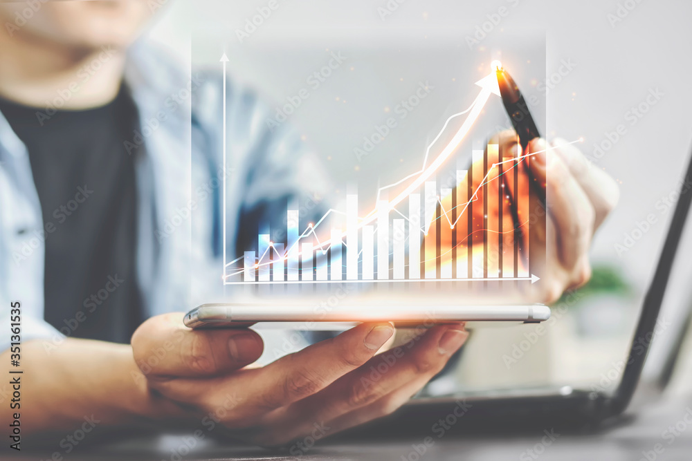 Business men use the pen to point at the graph of business growth ...
