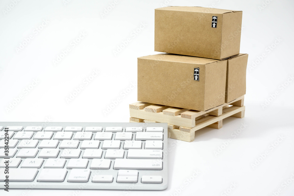 Cardboard Boxes Stacked On Wooden Pallet By Computer Keyboard Against ...