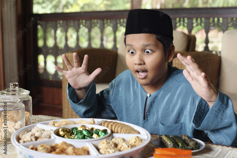 Boy looking at the variety of cookies with his eyes and mouth wide ...