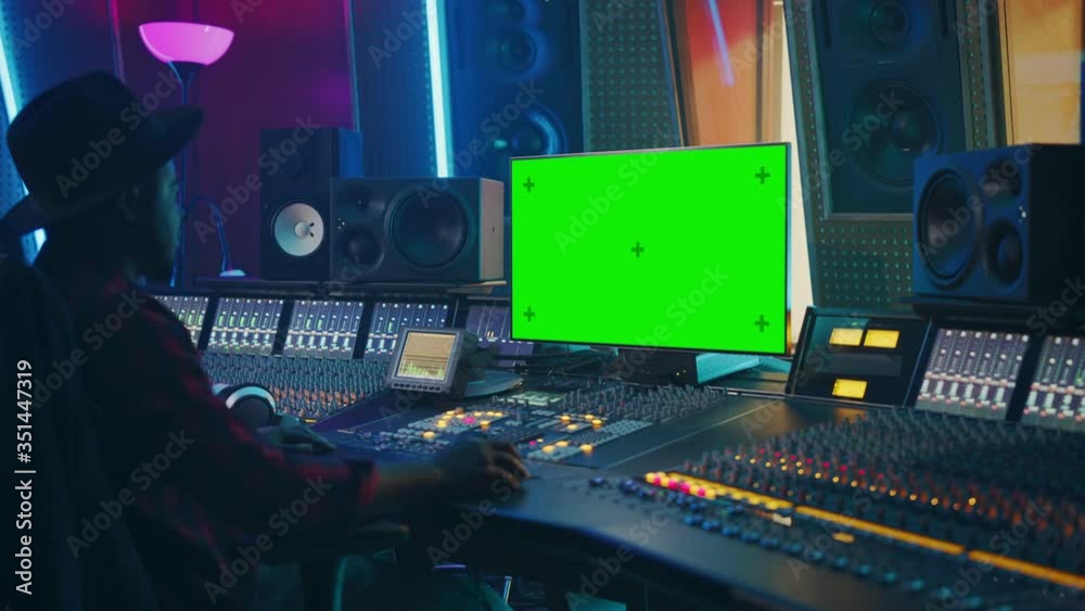 Stylish Audio Engineer / Producer Working in Music Record Studio, Uses ...