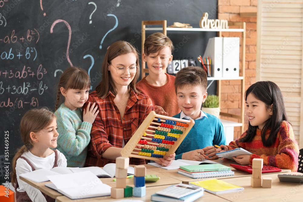 Children with math teacher during lesson in classroom Stock Photo ...