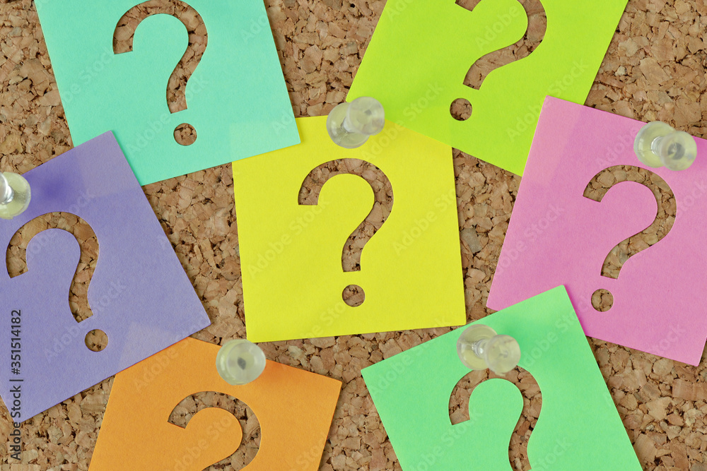 Post it notes with question mark on notice board - Concept of faq and ...