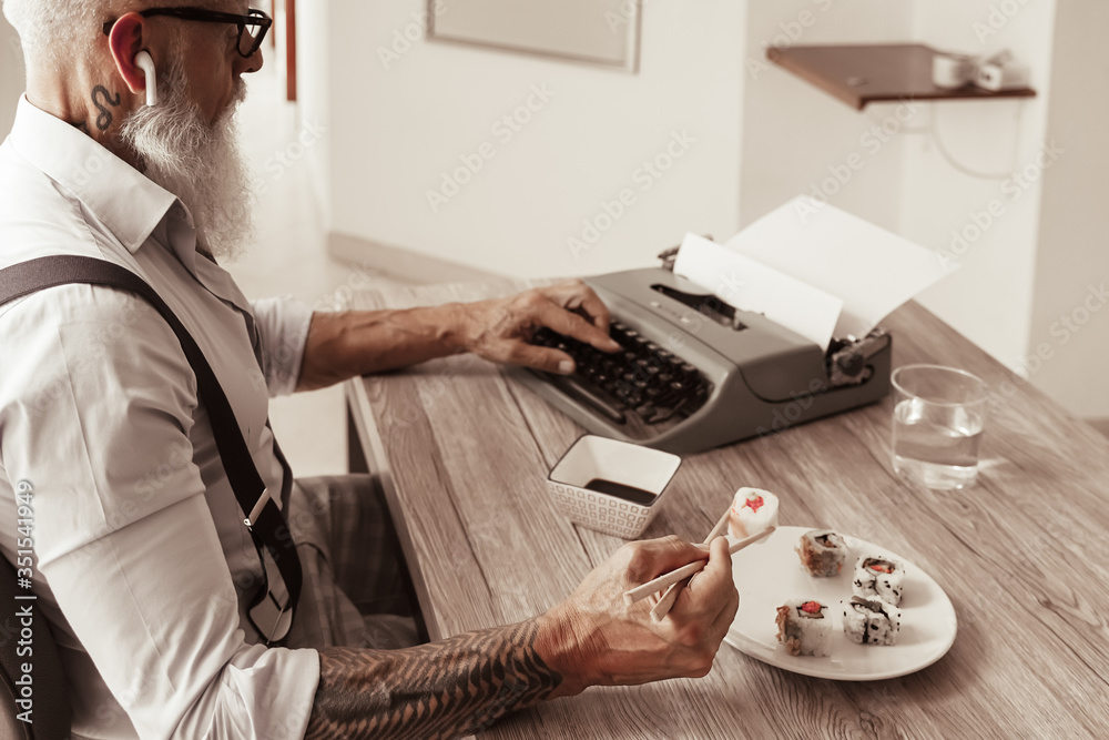 Man enjoying eating fresh colorful asian sushi using chopsticks. This ...