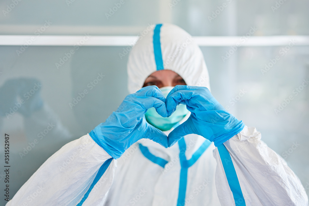 Clinic staff forms heart with hands in front of face as corona virus ...
