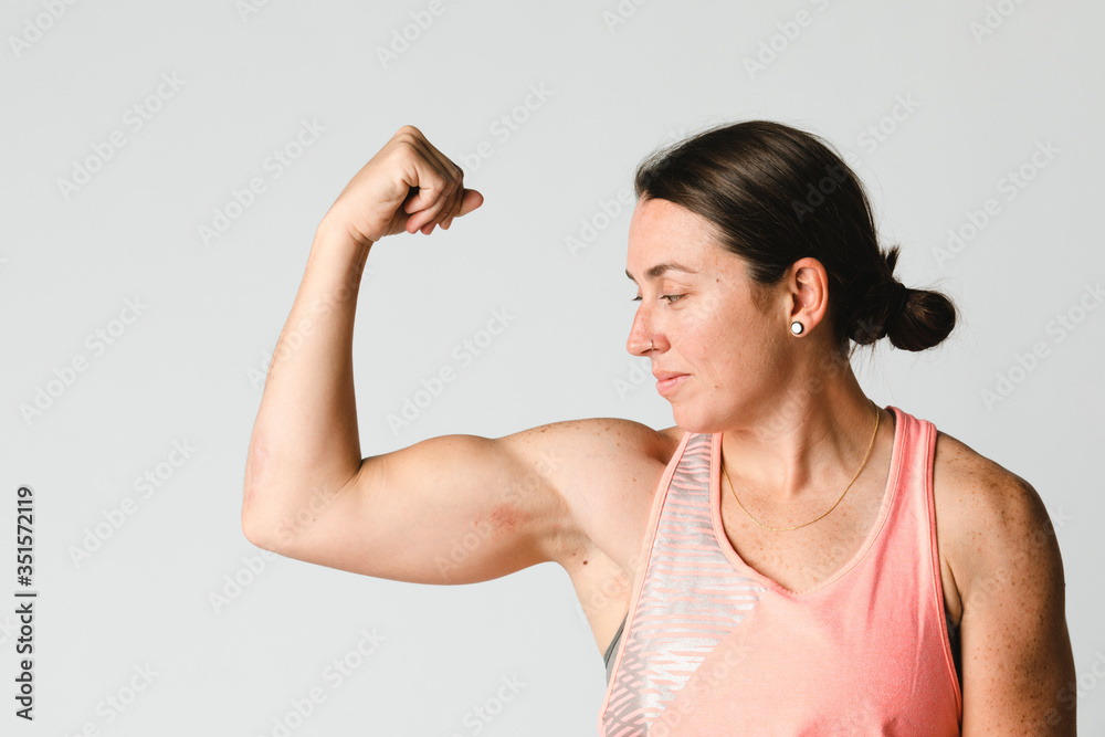 Female athlete flexing her arms Stock Photo | Adobe Stock