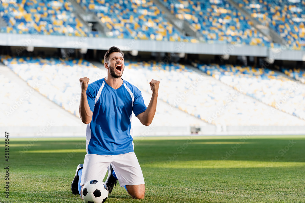 emotional professional soccer player in blue and white uniform with ...