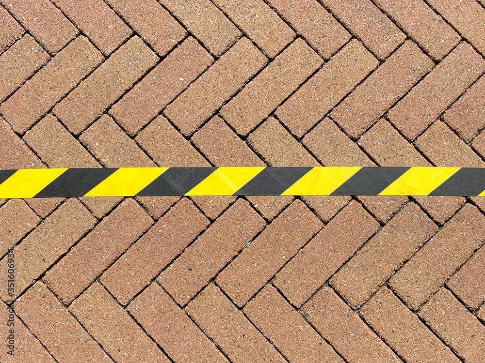 Isolated yellow black do not cross borderline border line on pavement ...