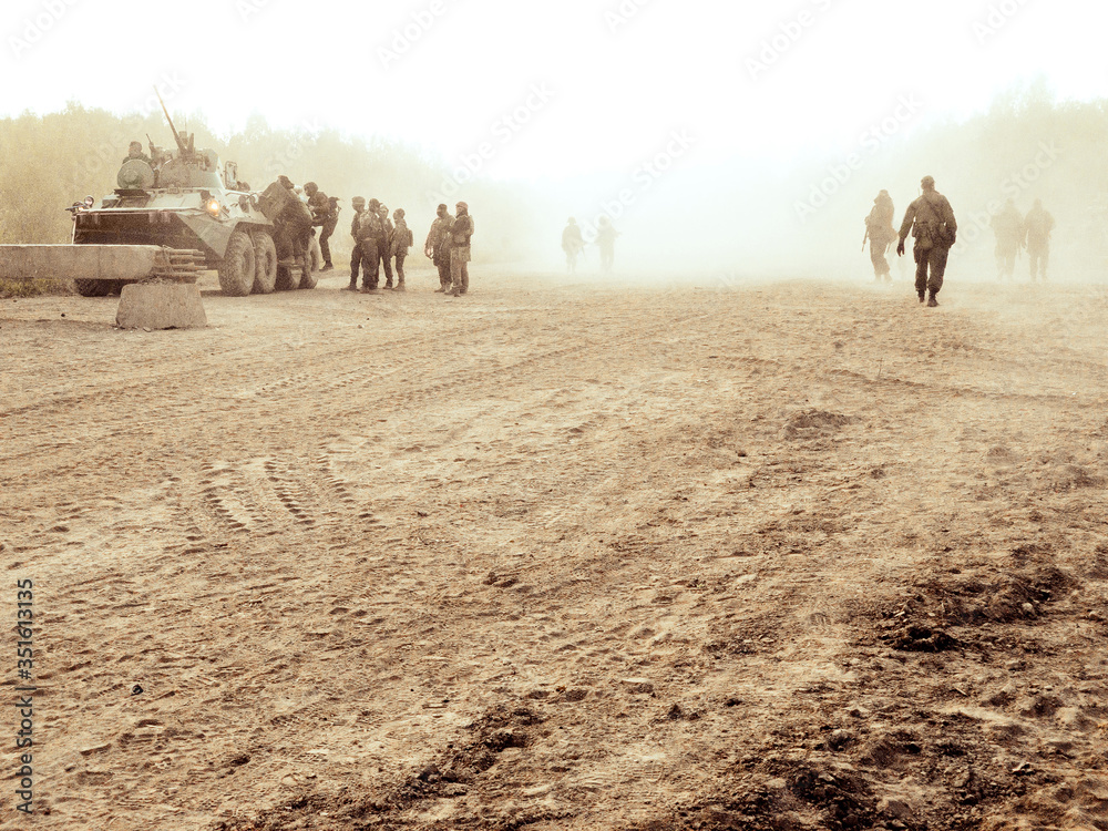 Tanks at firing positions. Battlefield. Sandstorm. A group of soldiers ...