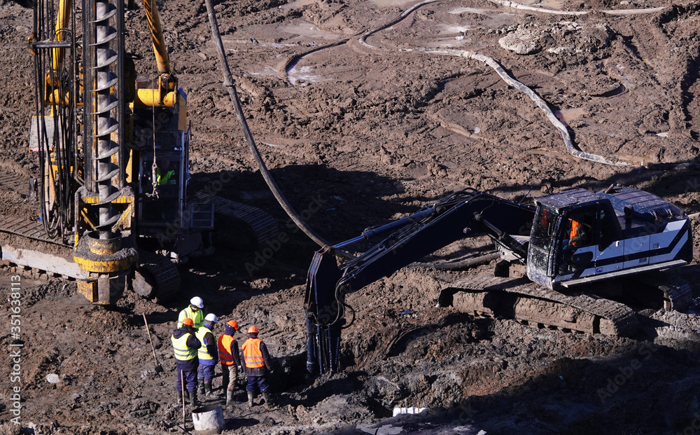 Drilling rig boring the ground pours a hole in the concrete for the ...