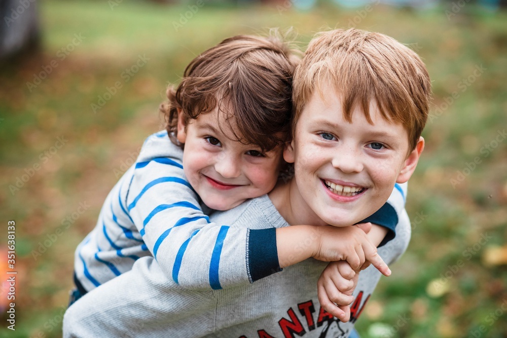 Two happy boys, happy brothers who are smiling happily together ...