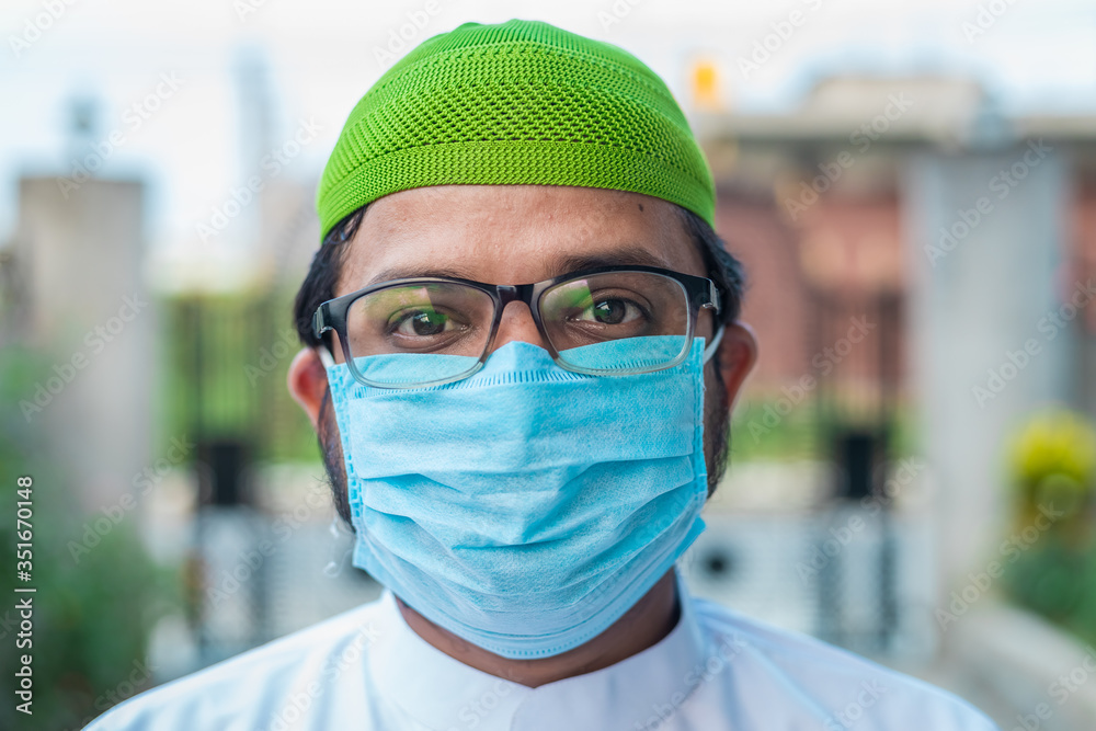 Closeup Asian Muslim man in traditional attire with face mask. Stock ...