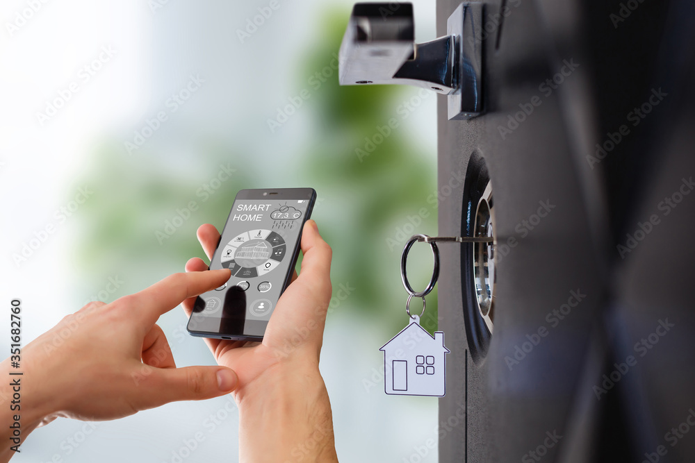 smart house, home automation, device with app icons. Man uses his ...