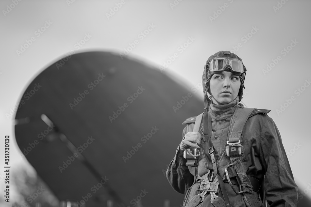 Retro style black and white. A young female pilot in uniform of Soviet ...