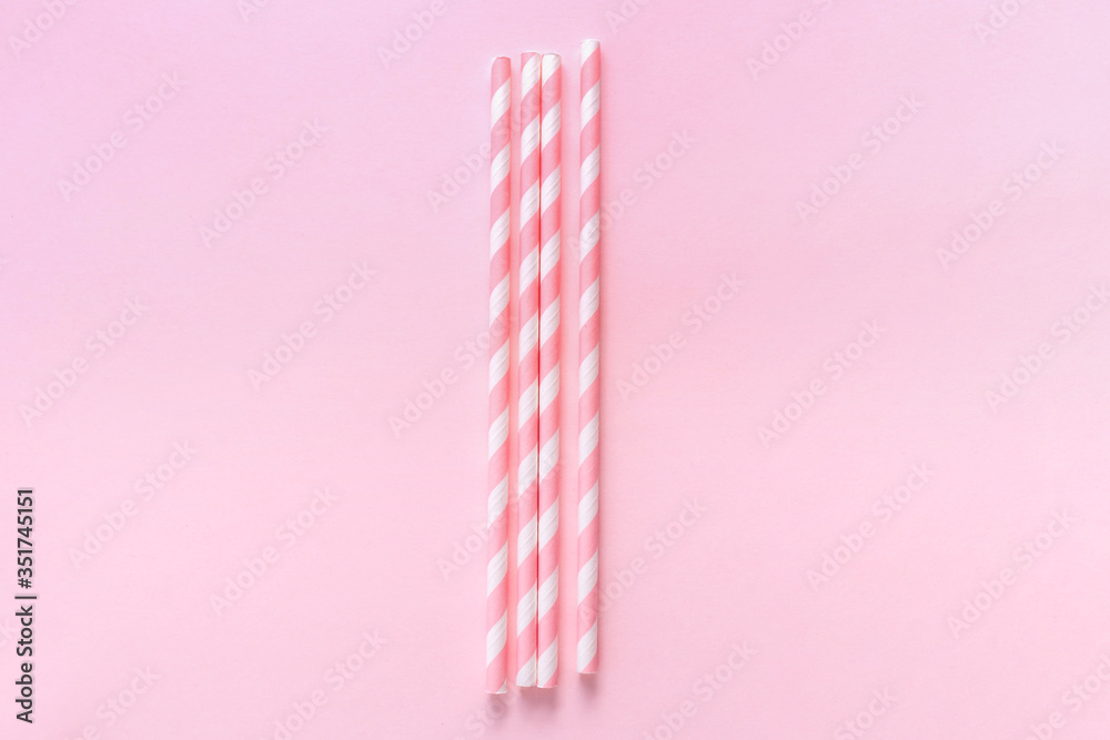 Pastel paper straws with white stripes on soft pink background. Zero ...