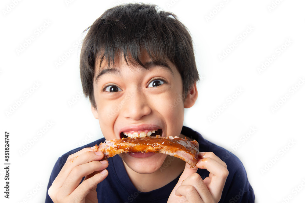 Little boy eating rib pork grill with happy face Stock Photo | Adobe Stock