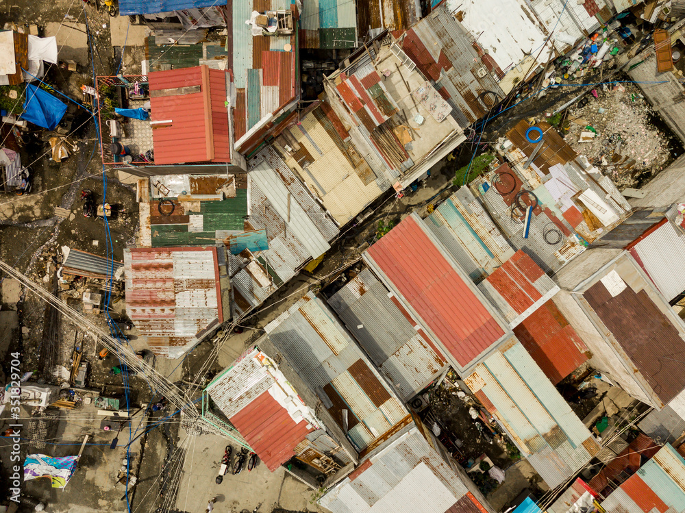 Top view of a squalid and impoverished squatter area with narrow ...