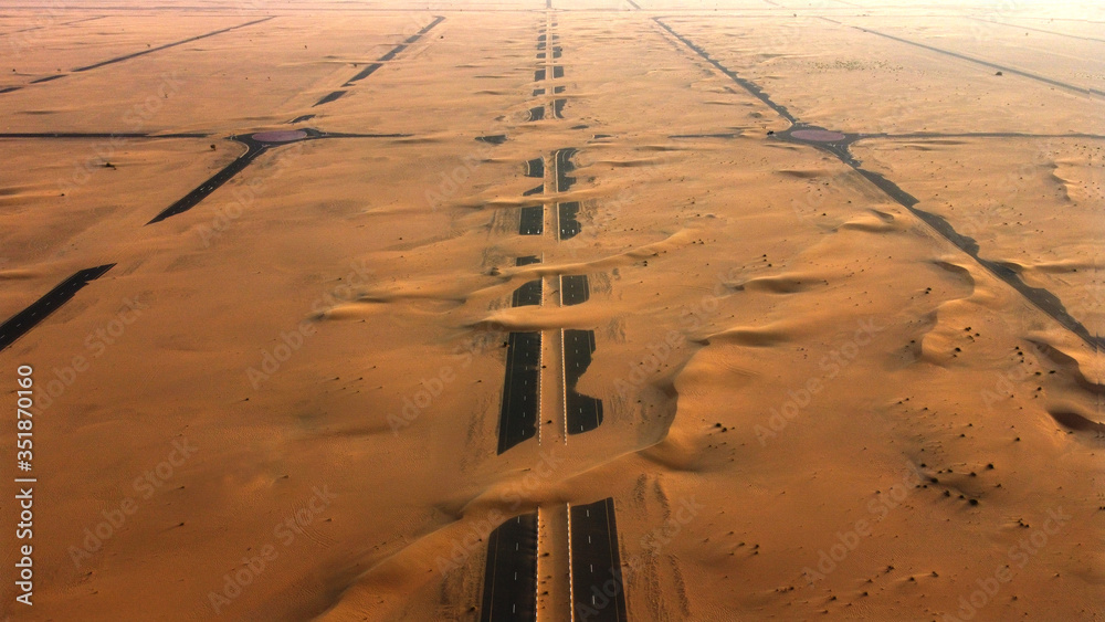 Long beautiful Dubai roads covered in sand at golden hour. Dubai Desert ...