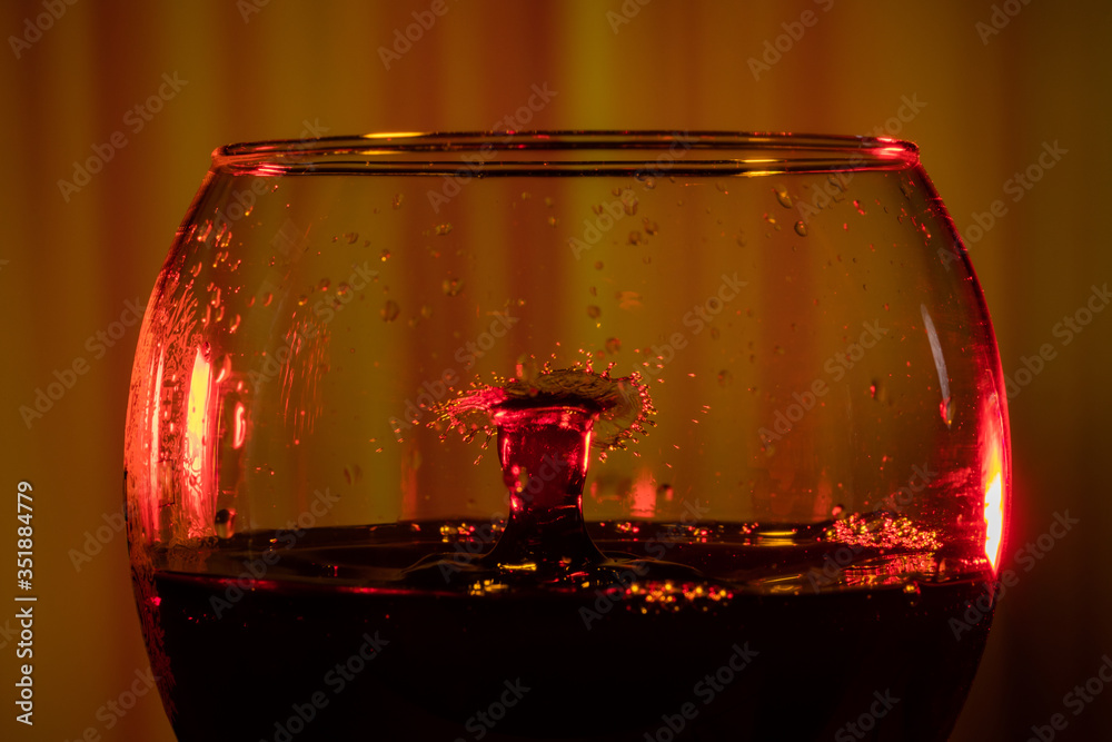 Red wine splash. Reaction of a falling drop on a red wine surface in a ...