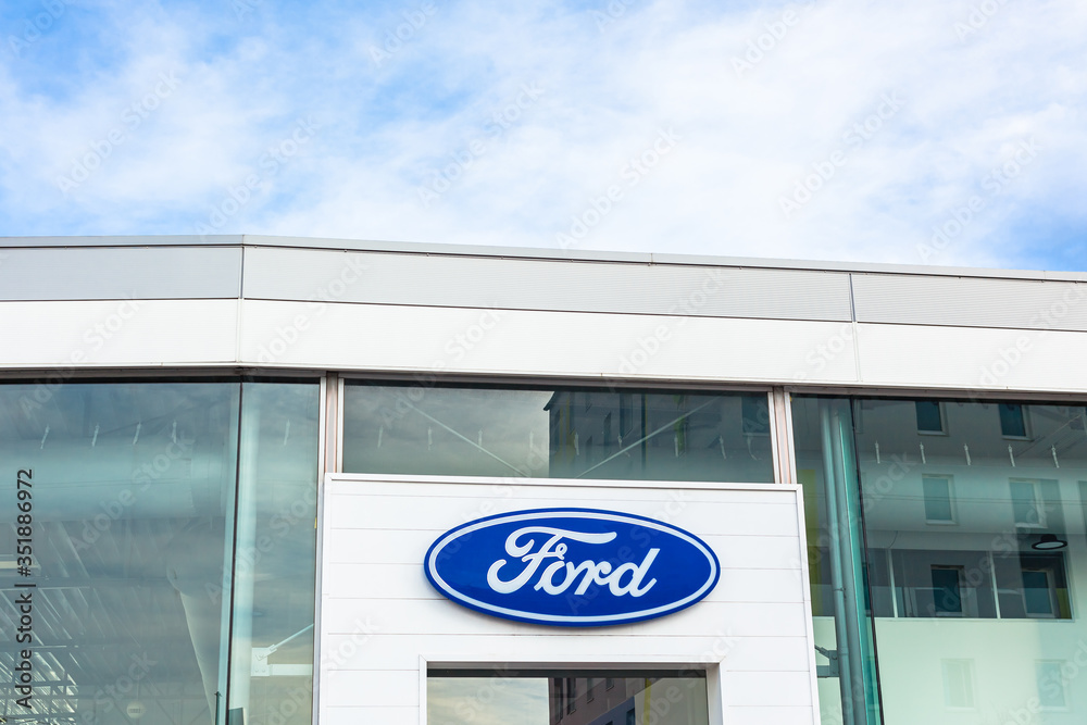 Ford brand logo on bright blue sky background Stock Photo | Adobe Stock