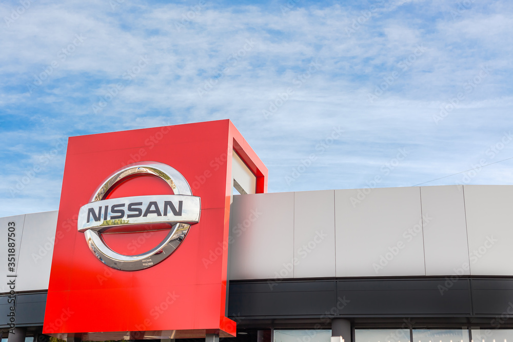 Nissan brand logo on bright blue sky background Stock Photo | Adobe Stock