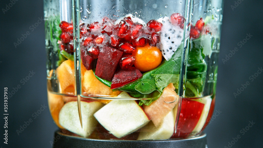 Fresh fruit and vegetables smoothie blended in blender, back view ...