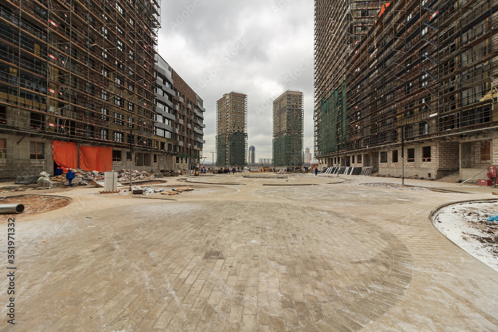 Tall building under construction with scaffolds. Construction site ...