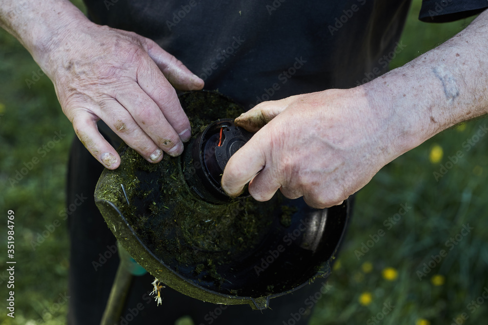 disassembly and installation of the line in the grass trimmer Stock ...