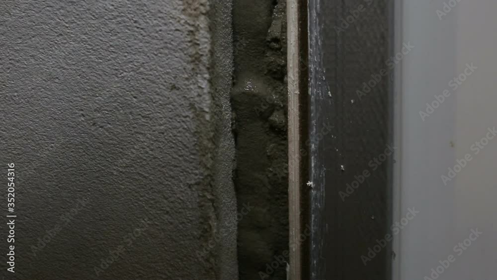 Filling the wall gap with cement mortar from sac a poche, squeezing the ...