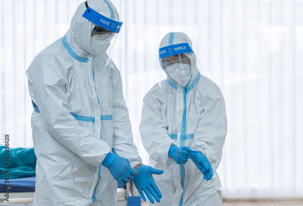 asian doctor and nurse wearing personal protective equipment or ppe to ...