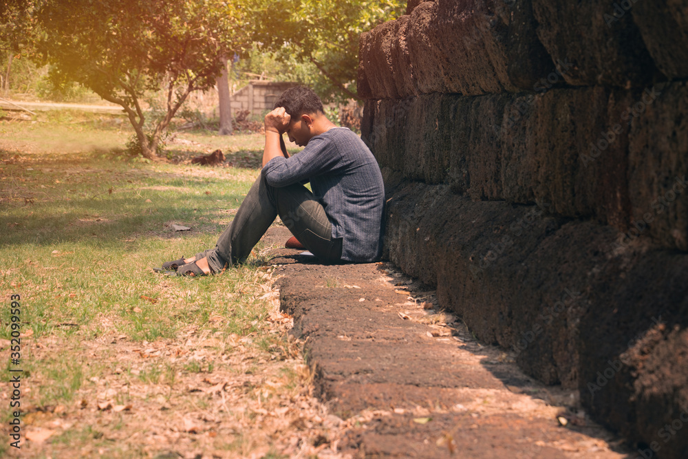 Asia you man sitting alone.He sitting alone beside old wall.man very ...