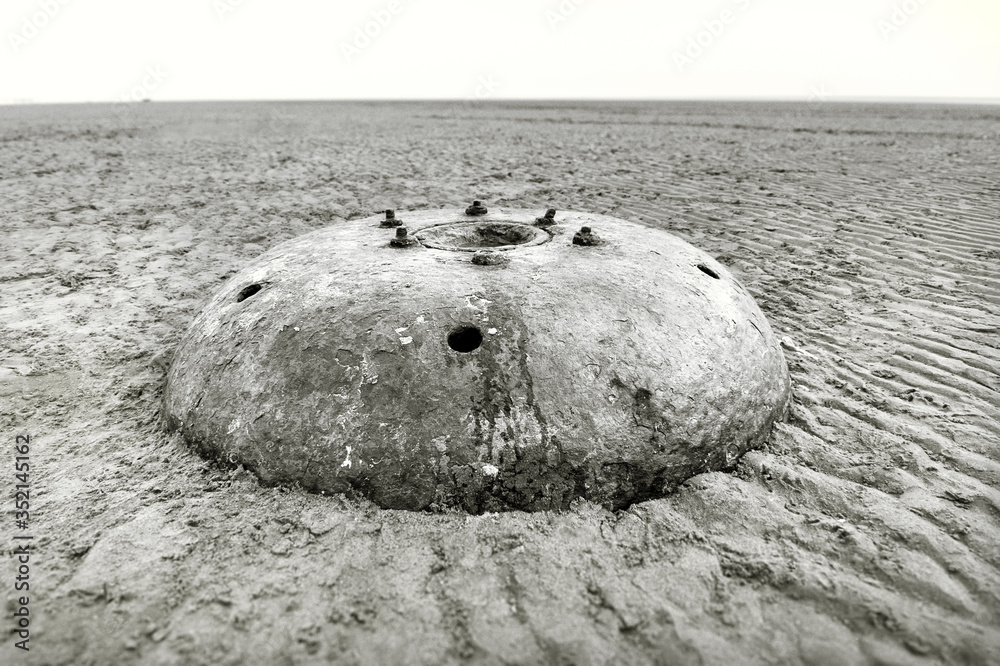 A big metal world war 2 underwater contact mine, washed up on an empty ...