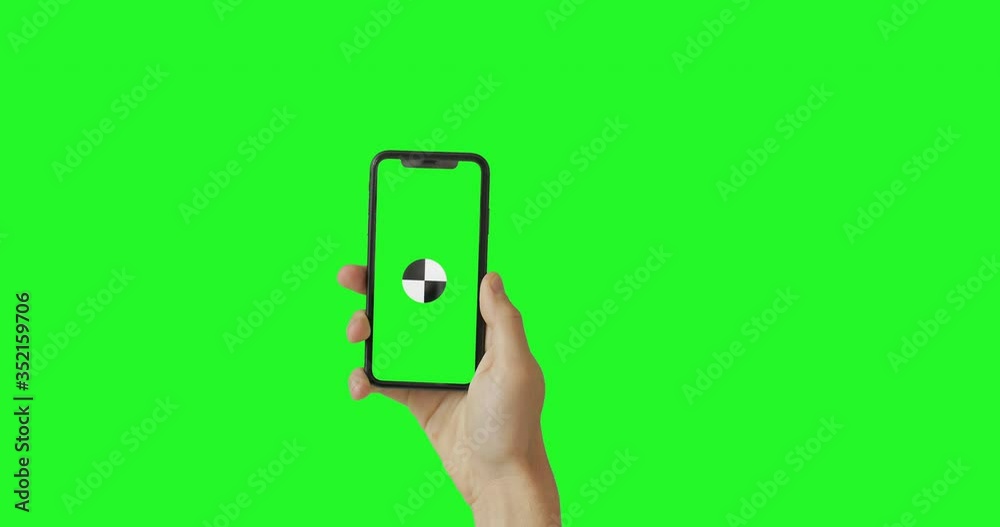 Woman hand holding the smartphone on green screen chroma key background ...