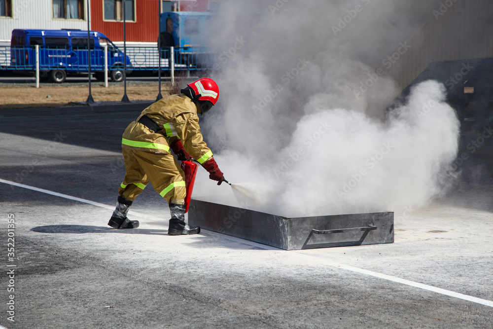 Extinguishing a major fire. A professional fireman in a special suit ...