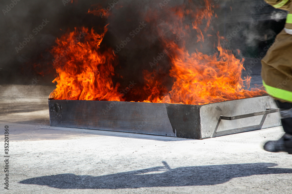 Extinguishing a major fire. A professional fireman in a special suit ...