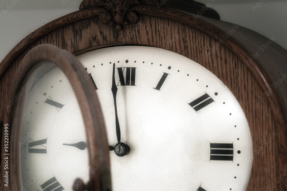 Close up of vintage antique brown handmade clock with roman numbers ...
