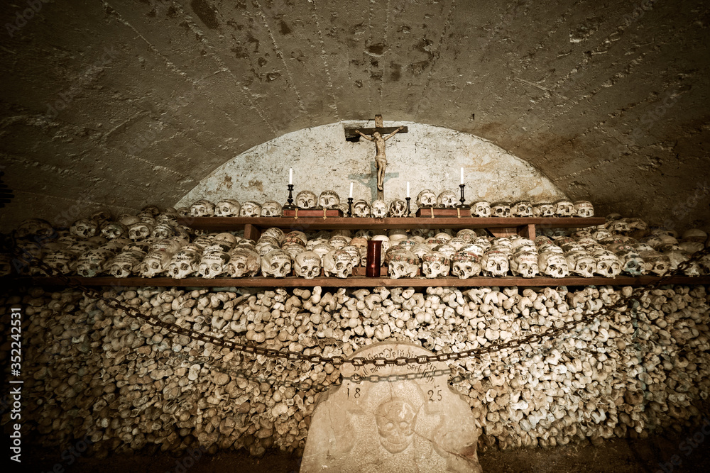 View of hundreds of painted skulls and bones inside the famous charnel ...