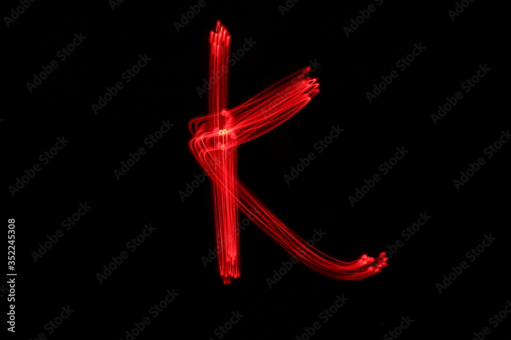 Long exposure photograph of the letter k in neon red colour fairy ...