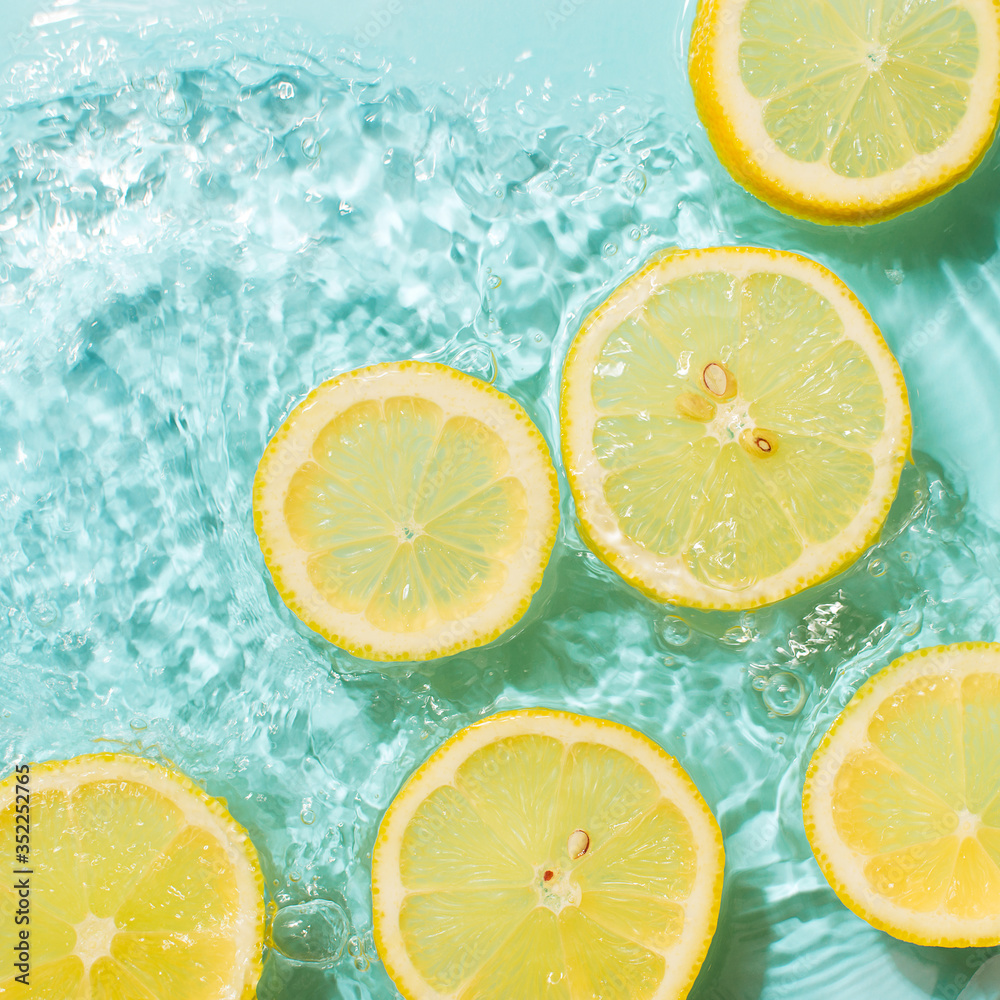 Slice of lemon underwater or in water with splashing and droplet top ...