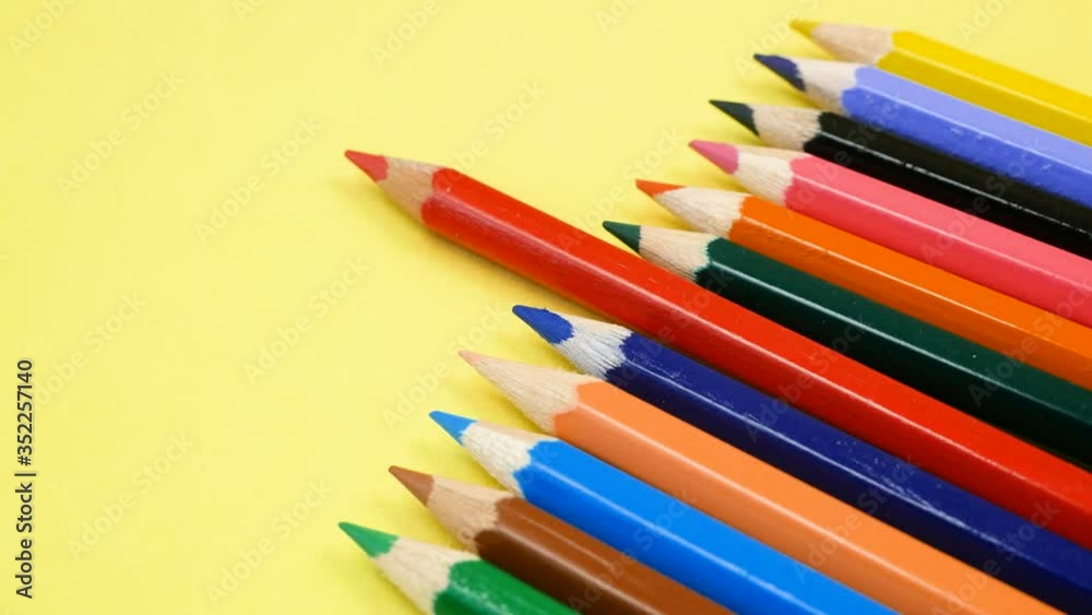 Colorful Pencils raw with a red pencil standing out from the crowd on ...