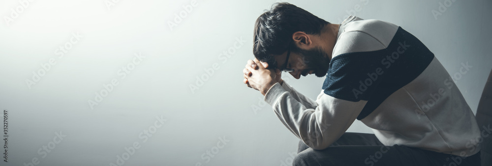 sad man in dark background Stock Photo | Adobe Stock