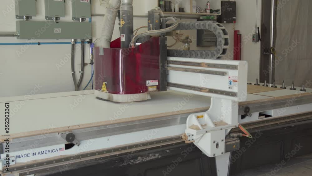 Large router table in clean workshop operating by computer instruction ...