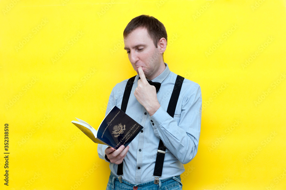 handsome tricky man in blue shirt and suspender reading usa ... handsome tricky man in blue shirt and suspender reading usa ...
